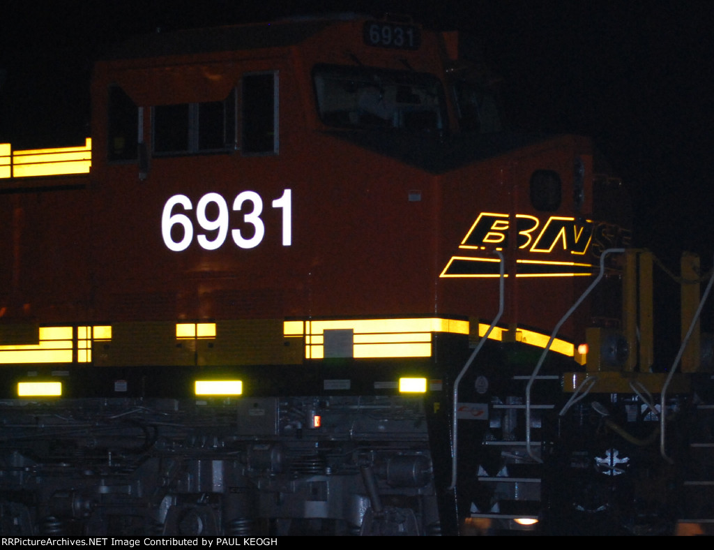 Close in shot of the cab of BNSF 6931 as she rolls east with a Double Stack Train.